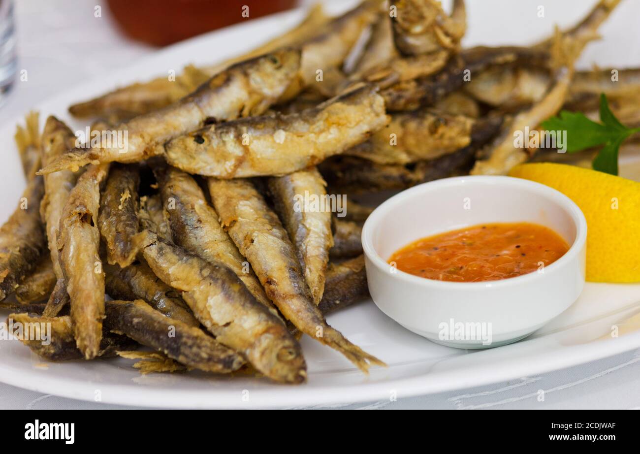 Fried fresh sprat fish with souce. Good seafood Stock Photo - Alamy