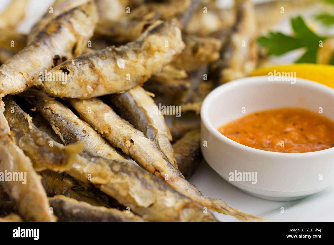 Fried fresh sprat fish with souce. Good seafood Stock Photo - Alamy