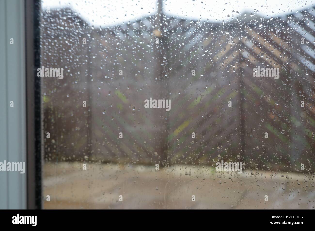 A view looking through a rain splashed double glazed window showing a ...