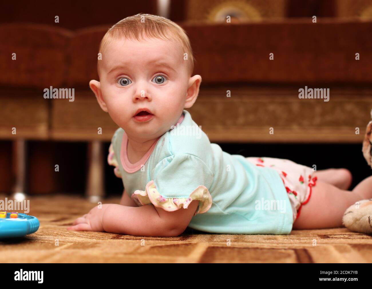 Surprised Baby on the Floor Stock Photo - Alamy