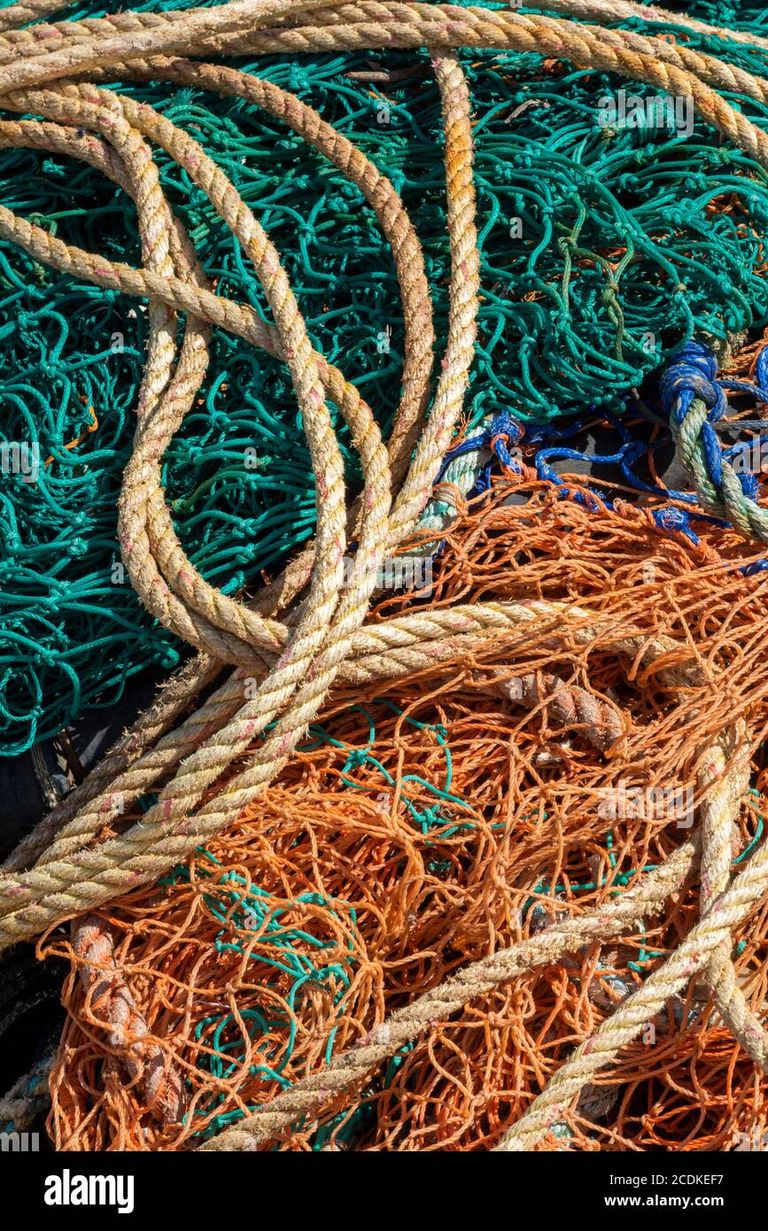 a tangle of knotted lines and wires with coloured ropes and nets on a ...