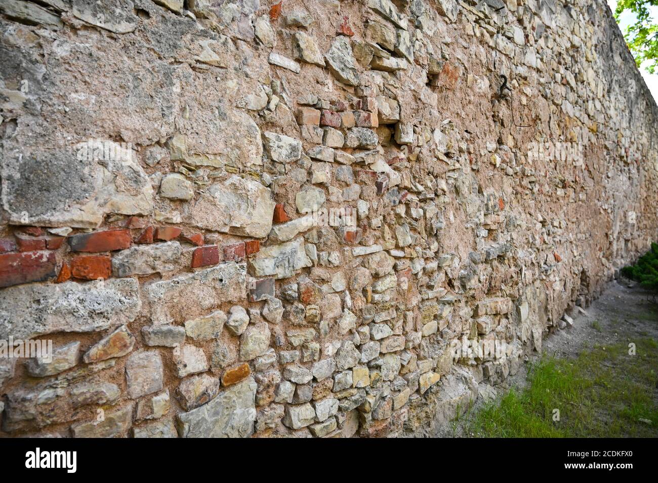 Old brick fortress wall of a small castle. Perspective view of the ...