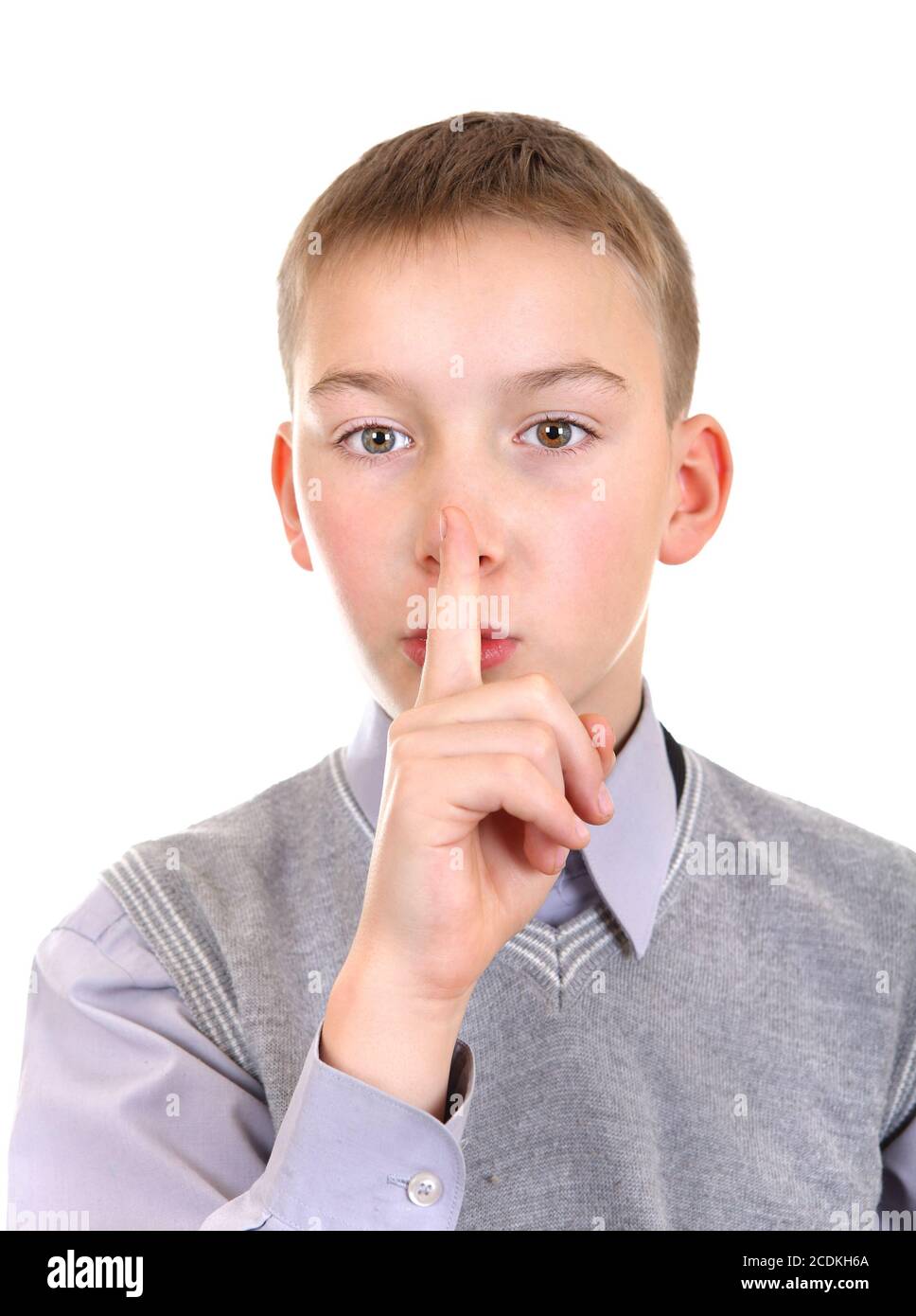 Boy with Finger on his Lips Stock Photo - Alamy