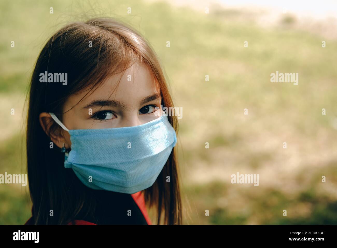 Little girl wearing the mask protecting from virus and air pollution ...