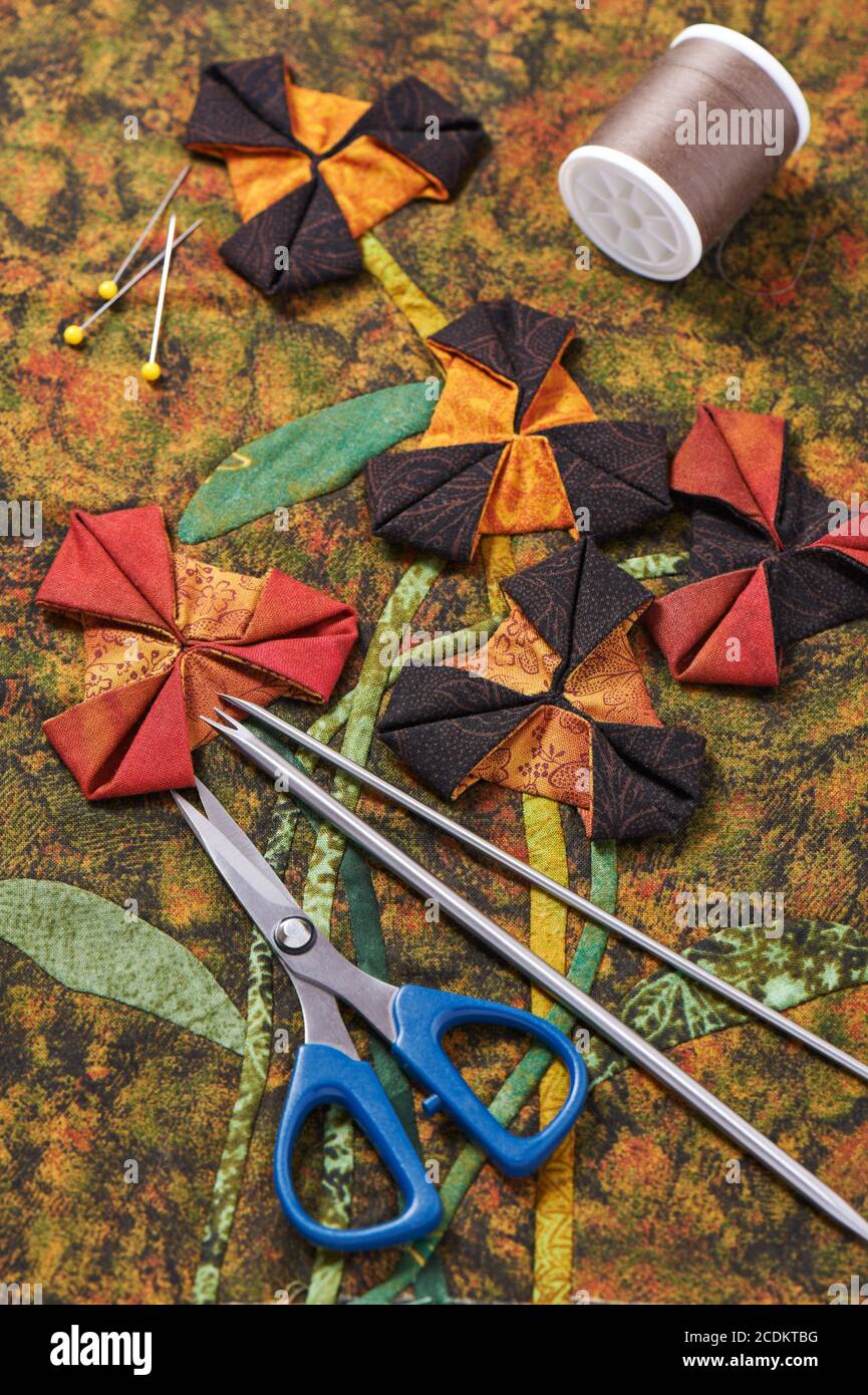 Tools for applique to fabric and detail of the quilt Stock Photo - Alamy