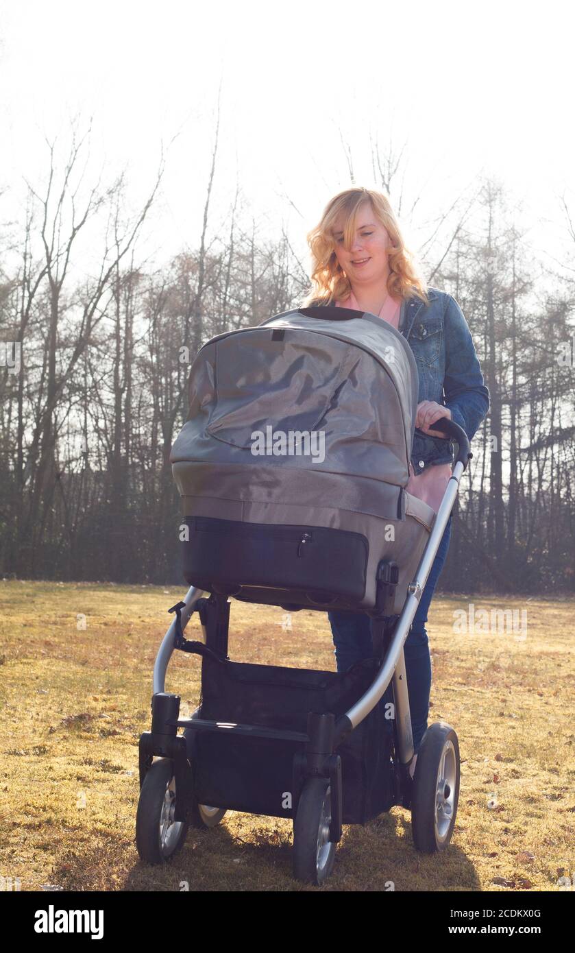 Young mother and a pram Stock Photo - Alamy