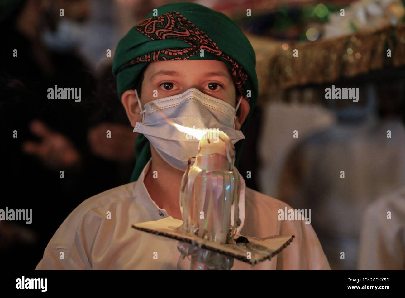 Baghdad, Iraq. 28th Aug, 2020. A Shia boy holds a lit candle during a ...