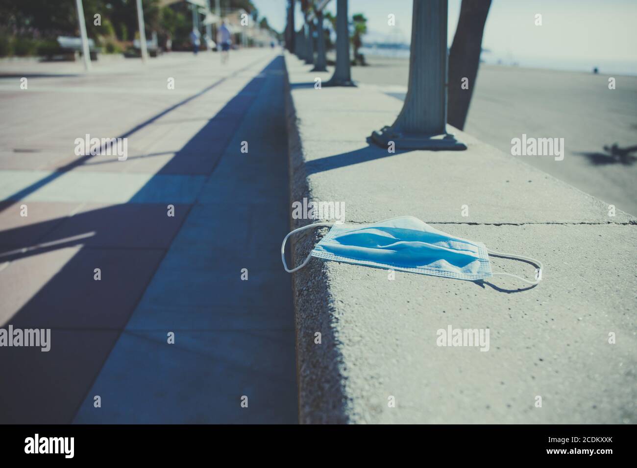 Medical face mask in the street Stock Photo - Alamy