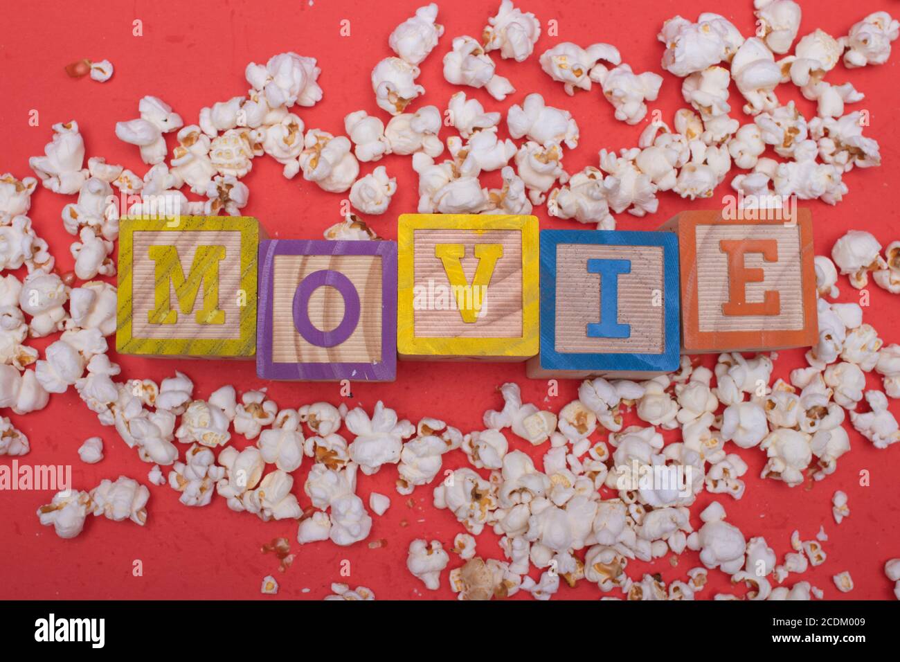 Word Movie written with wooden blocks with popcorn Stock Photo - Alamy