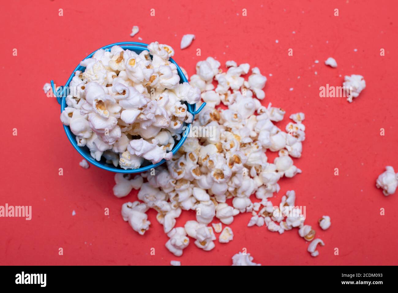 Popcorn on a red background Stock Photo - Alamy