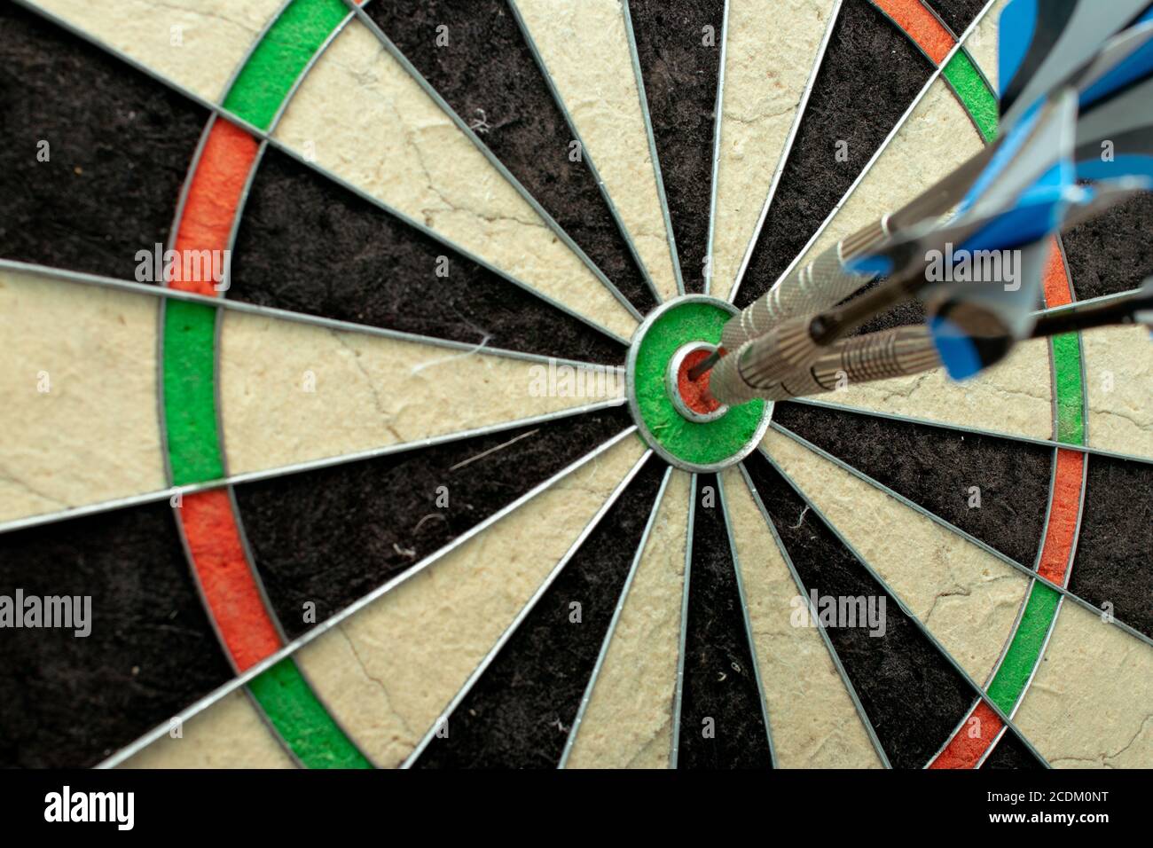 Three darts in the target center Stock Photo - Alamy