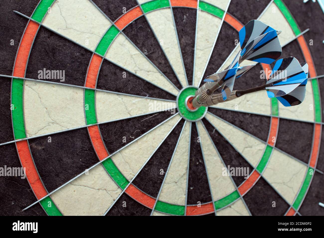 Three darts in the target center Stock Photo - Alamy