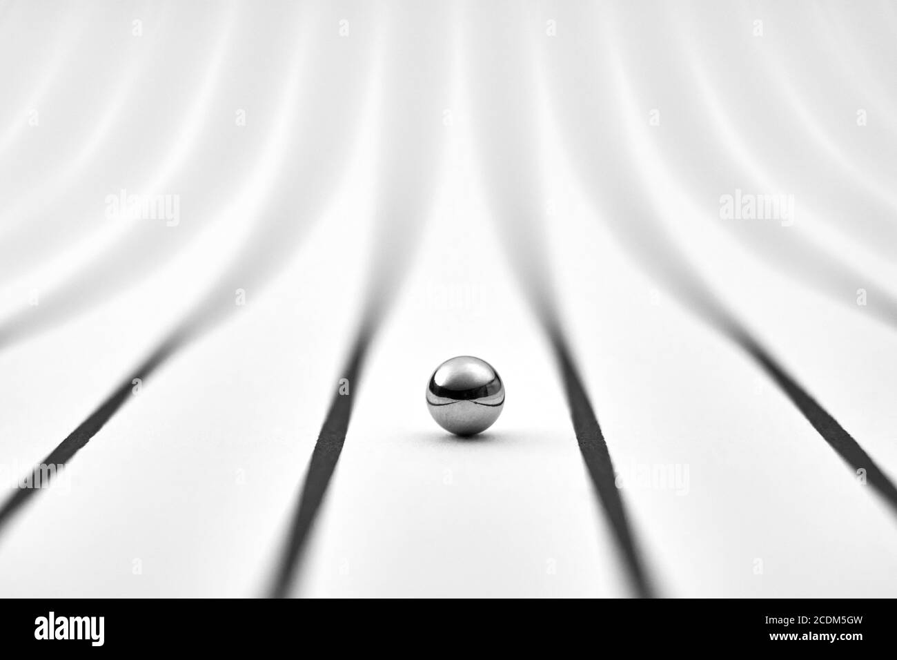 metal ball on a perspective of lines, macro photography in black and ...
