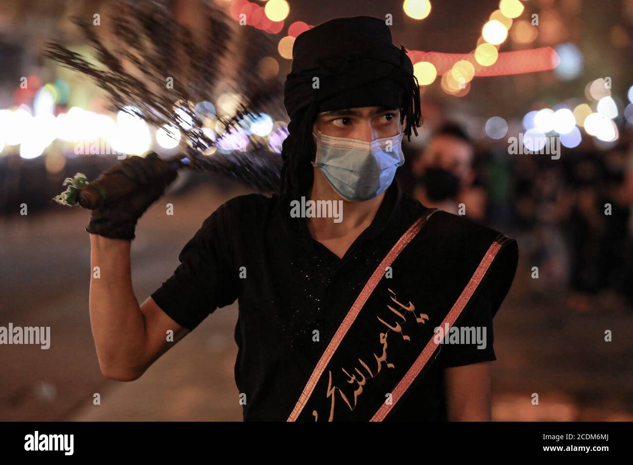 Bagdad, Iraq. 28th Aug, 2020. A Shiite Muslim man wearing a face mask ...