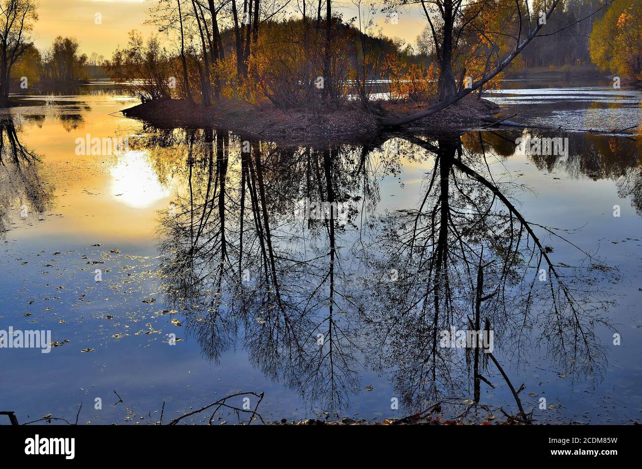Twilight autumn evening with reflection of sun in Stock Photo - Alamy
