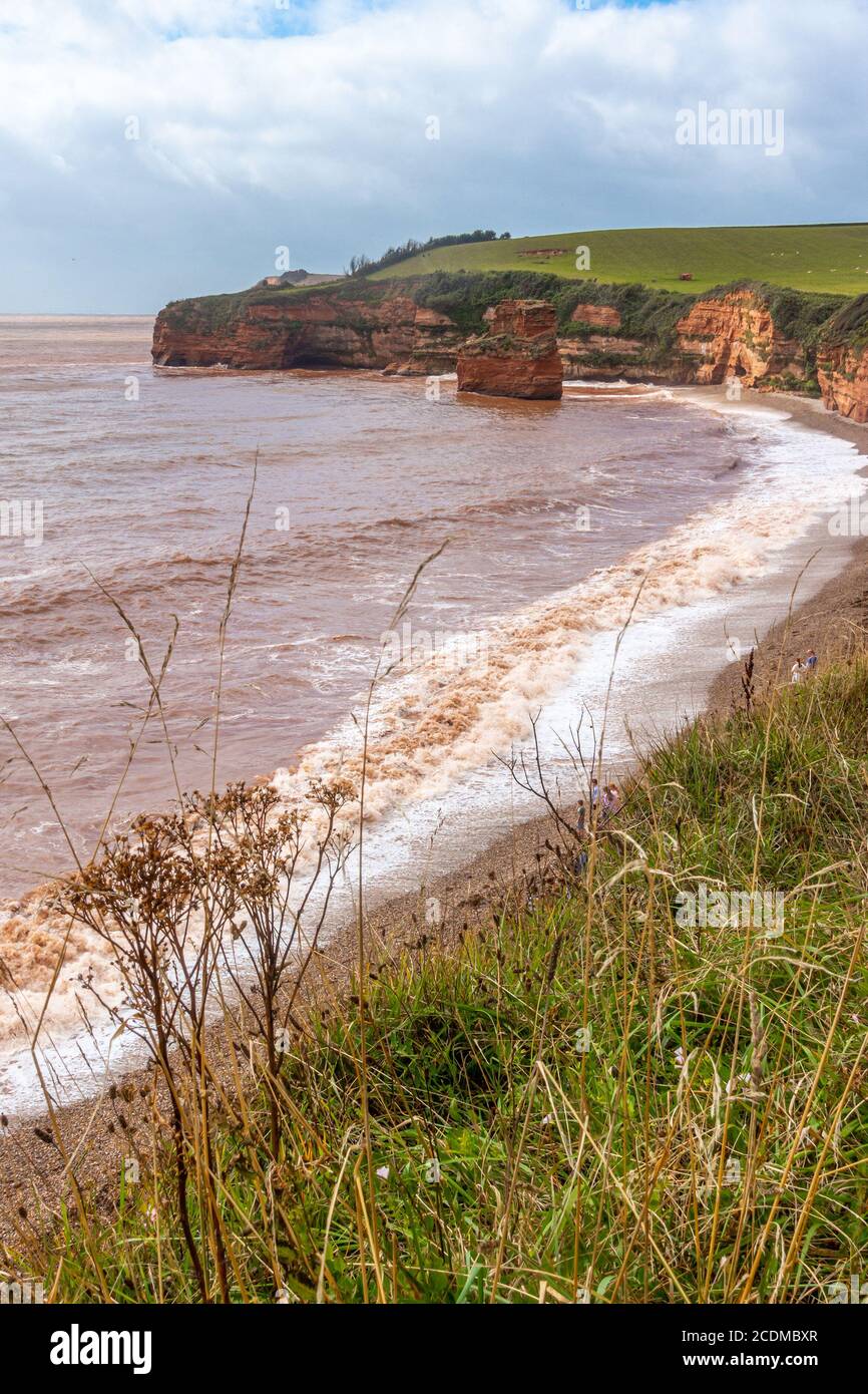 Waves breaking onto the beach at Ladram Bay near Exmouth in South Devon ...