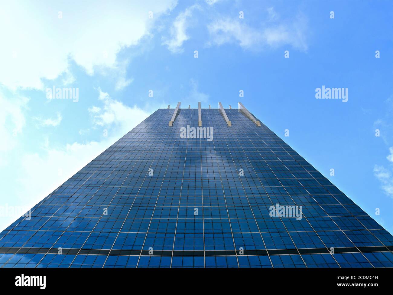 Upward perspective of a mirrored multi storey tower block against a ...