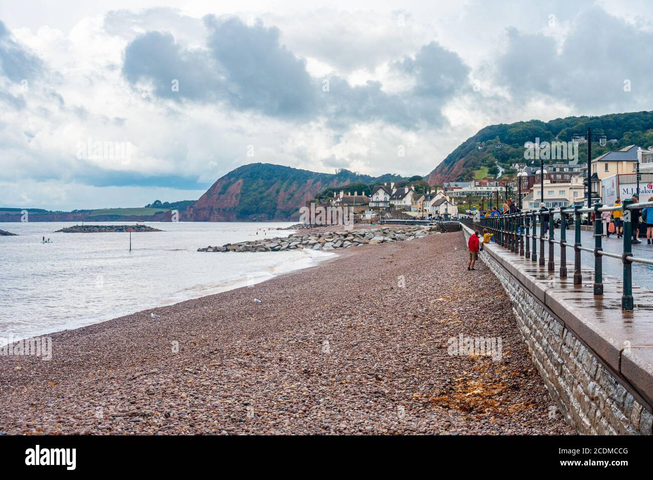 A view along Sidmouth beach in South Devon, UK on a cloudy and wet day ...