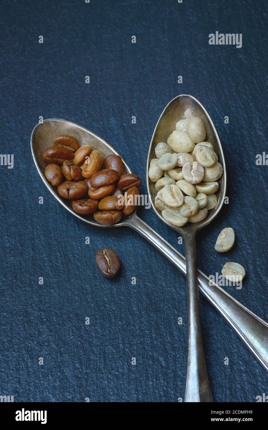 Green coffee and roasted coffee beans in spoon, Germany Stock Photo - Alamy
