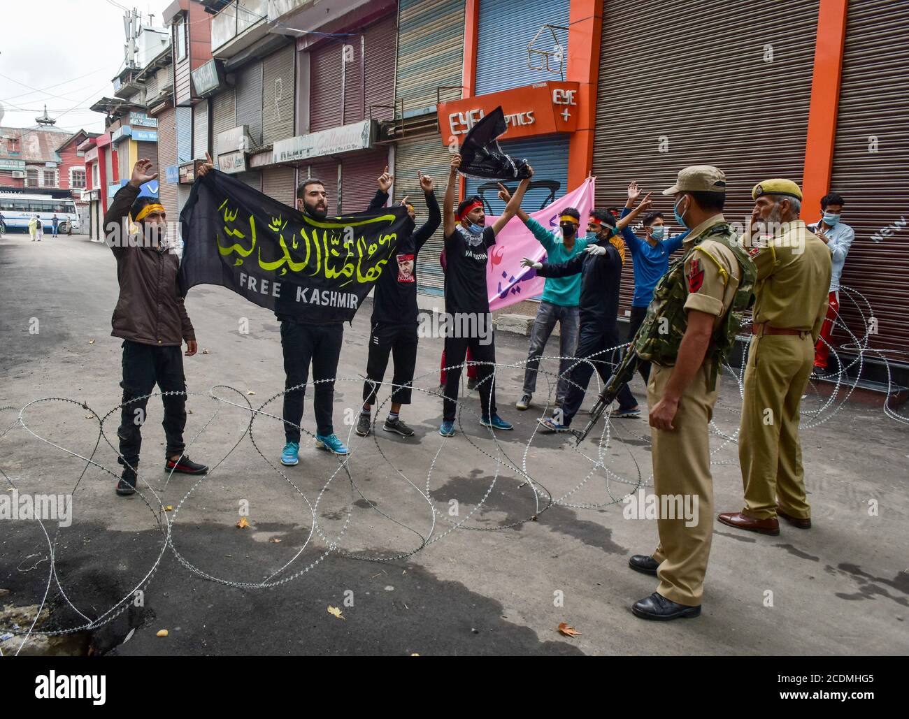 Kashmiri Shiite Muslims devotees hold banners as they shout religious ...