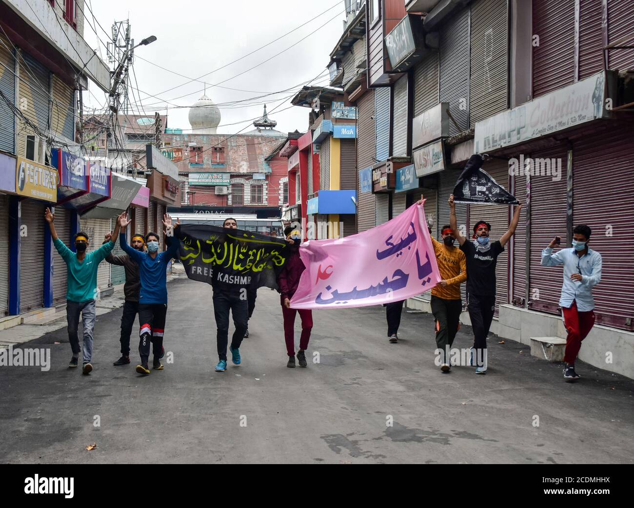 Kashmiri Shiite Muslim devotees hold banners as they try to defy ...