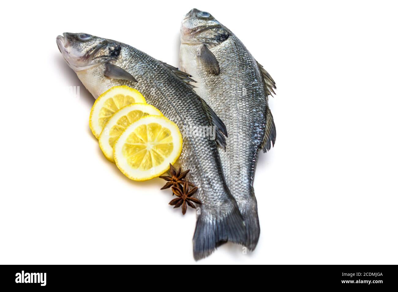 Sea bass fish whit lemon and star anise on withe background Stock Photo ...