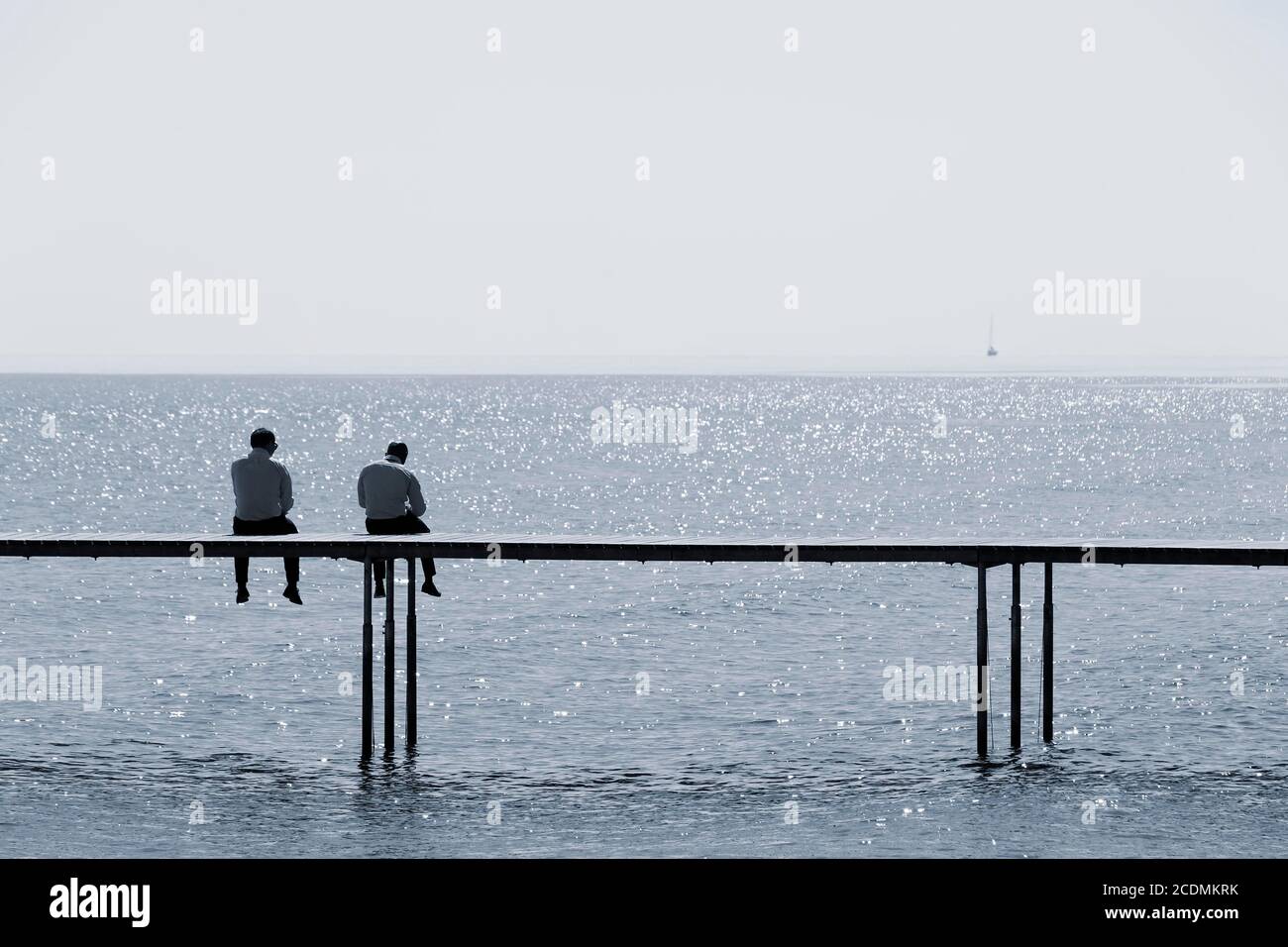 Silhouette people sitting on jetty hi-res stock photography and images ...