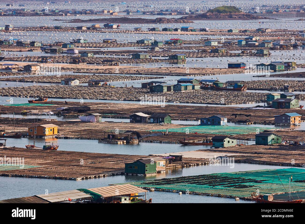 Floating city in bay, houses on bamboo constructions with aquacultures ...