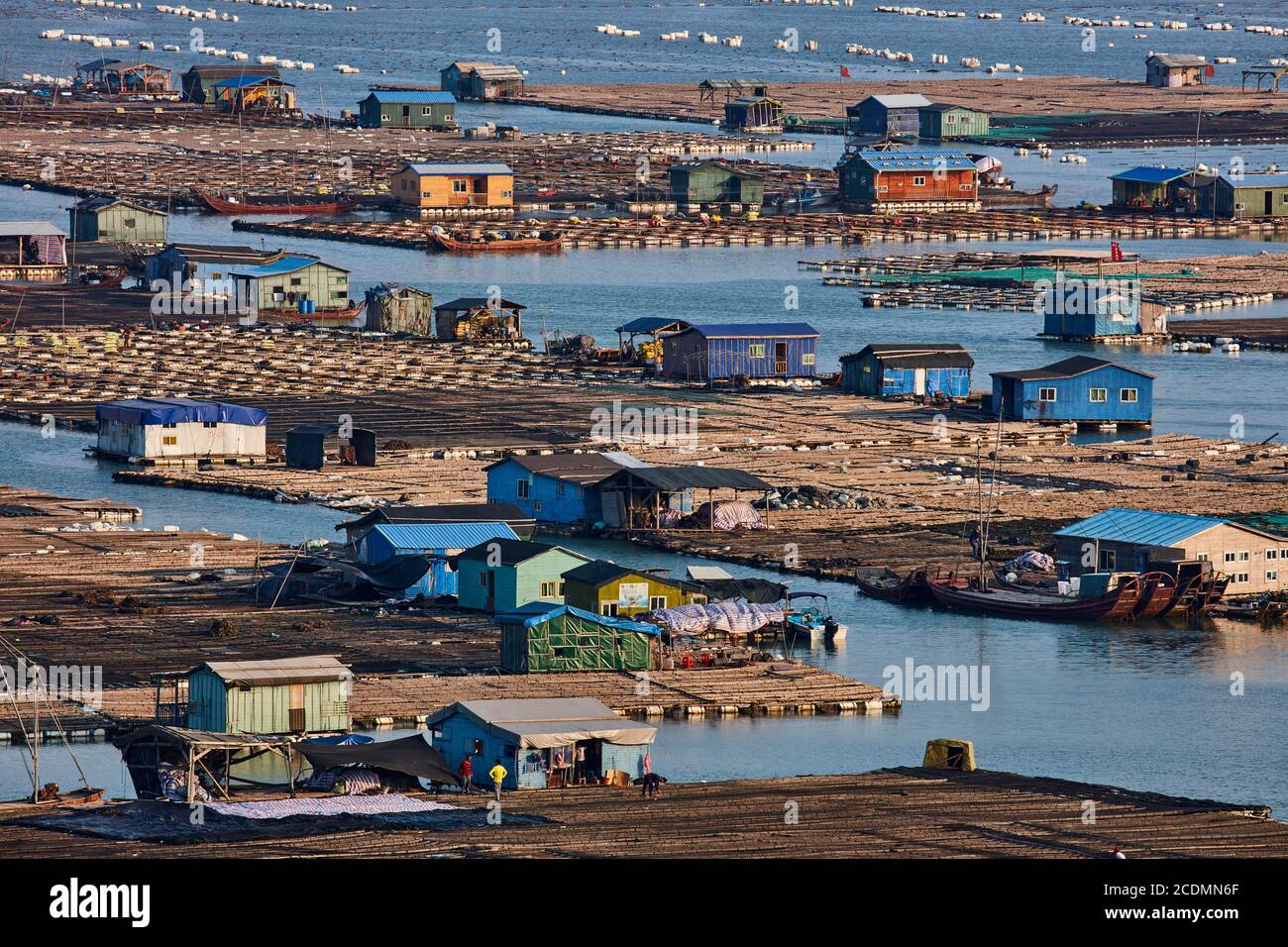 Floating city in bay, houses on bamboo constructions with aquacultures ...