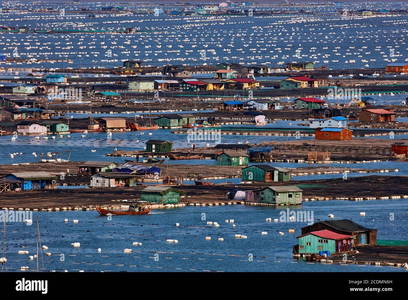 Floating city in bay, houses on bamboo constructions with aquacultures ...