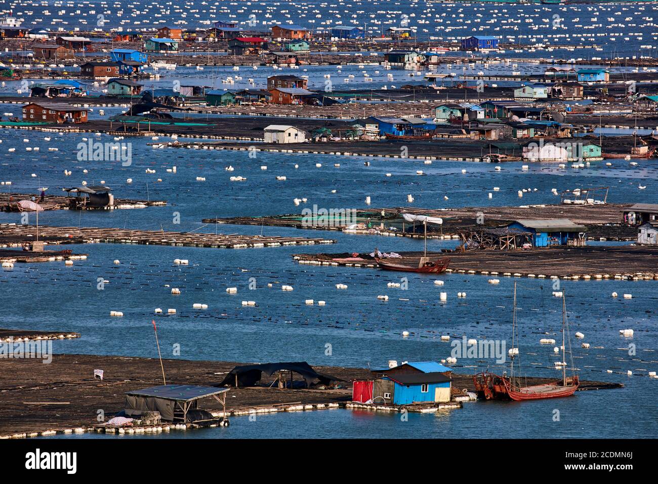 Floating city in bay, houses on bamboo constructions with aquacultures ...