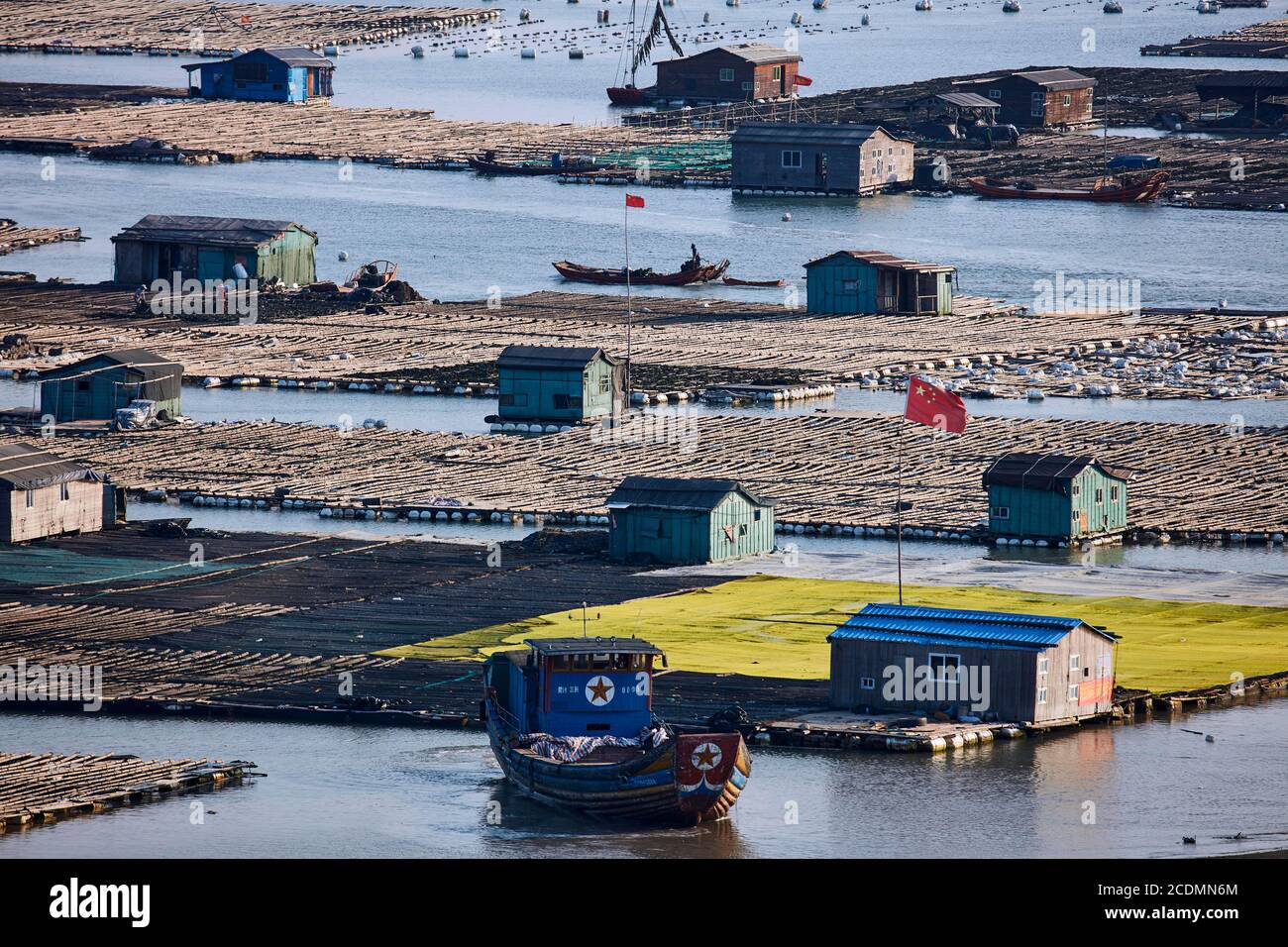 Floating city in bay, houses on bamboo constructions with aquacultures ...