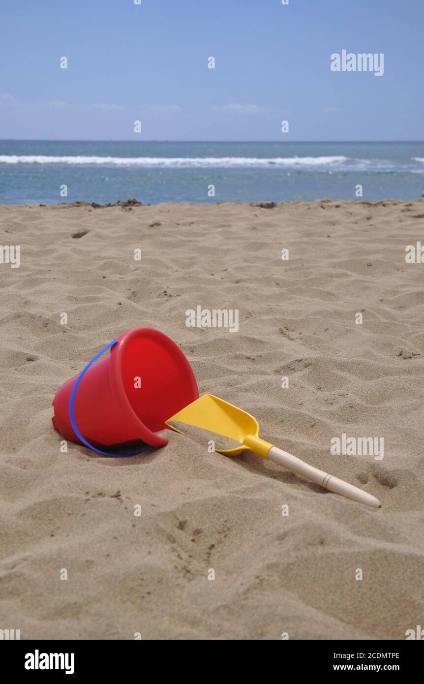 Sandy beach (with bucket and shovel Stock Photo - Alamy
