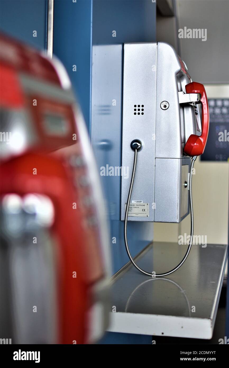 Red and silver pay phones at a train station Stock Photo - Alamy
