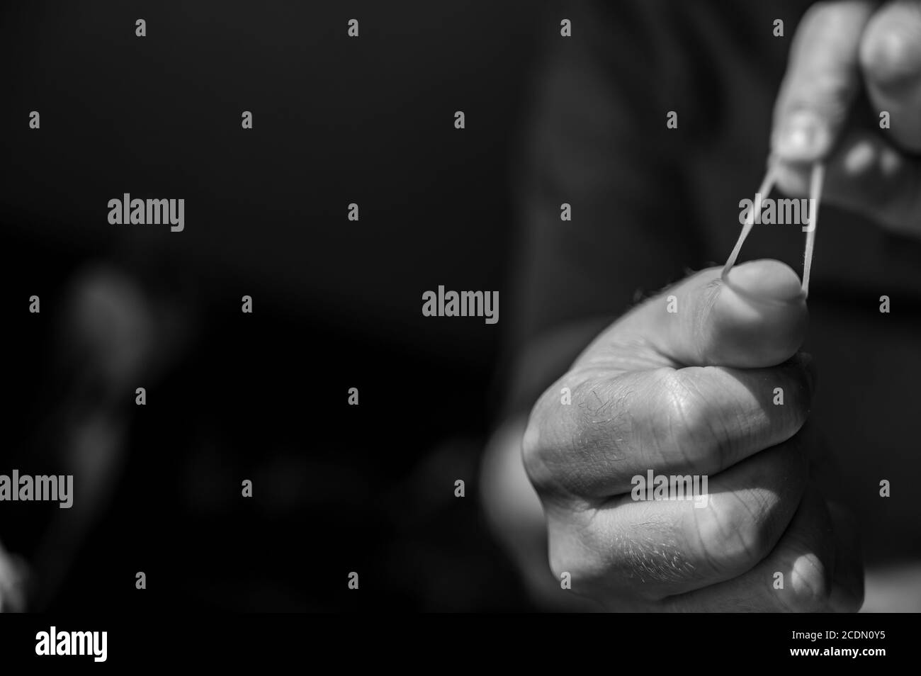 Pulling rubber band with hand hi-res stock photography and images - Alamy