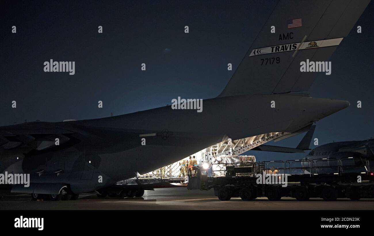 U.S. Airmen assigned to the 60th Aerial Port Squadron, load pallets ...
