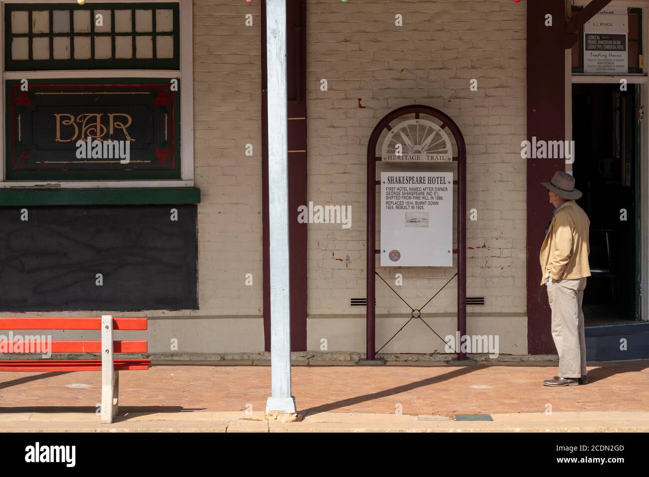 Man looking at sign detailing history of Shakespeare Hotel. Barcaldine ...