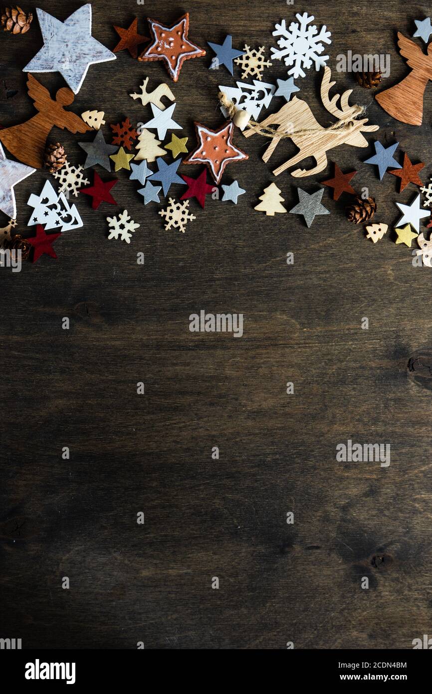 Christmas cad concept with holiday wooden decoration on dark moody ...