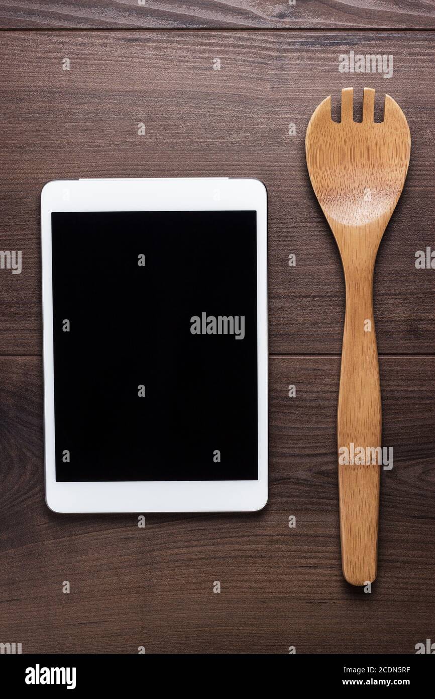 wooden spoon and tablet computer Stock Photo - Alamy