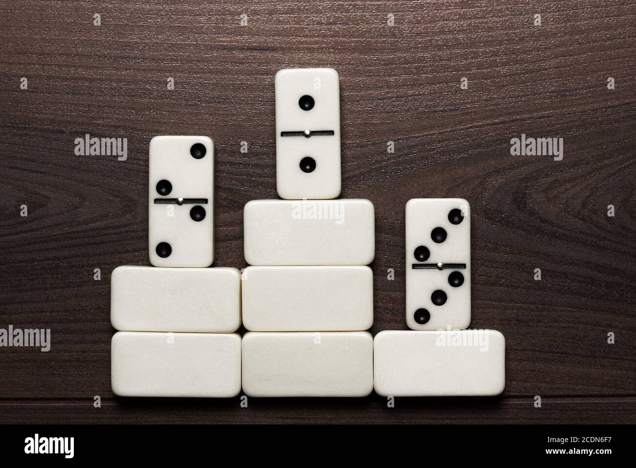 domino pieces win concept background Stock Photo - Alamy