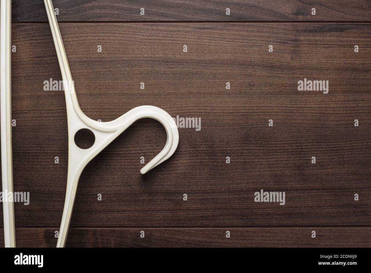 clothing hanger on brown table Stock Photo - Alamy