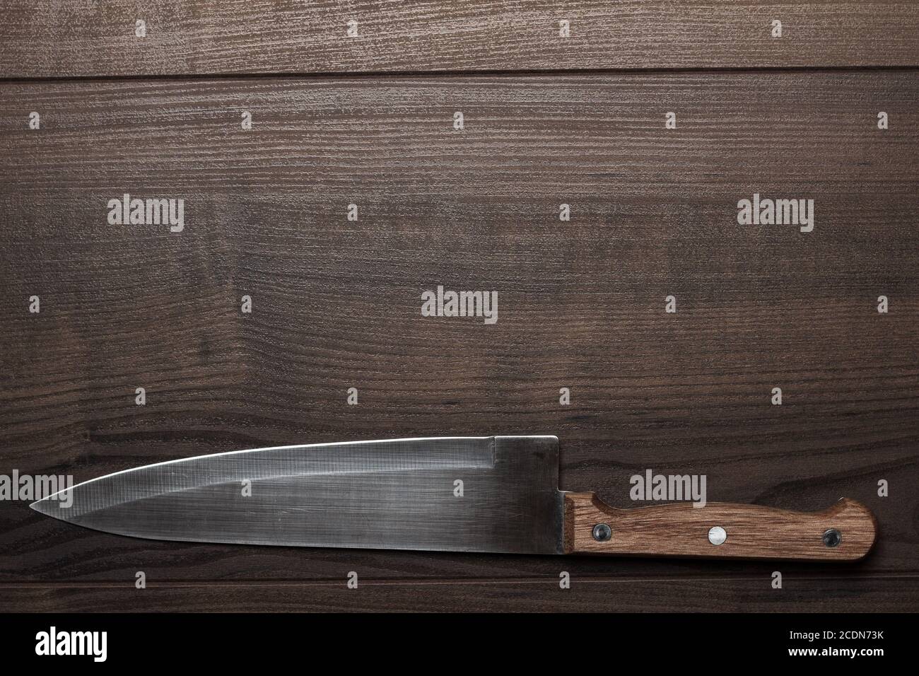 kitchen knife on brown wooden table Stock Photo - Alamy