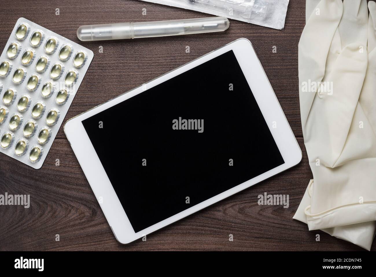 table with tablet computer pills and gloves on it Stock Photo - Alamy