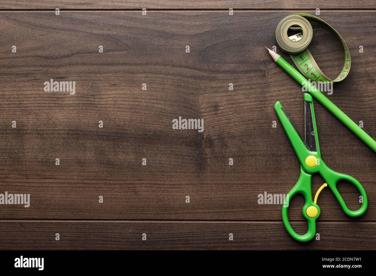 green measuring tape, scissors and pencil Stock Photo - Alamy
