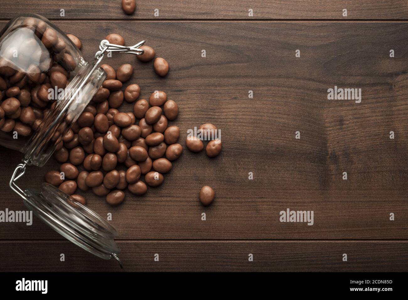 topple over glass jar full of chocolate sweets Stock Photo - Alamy