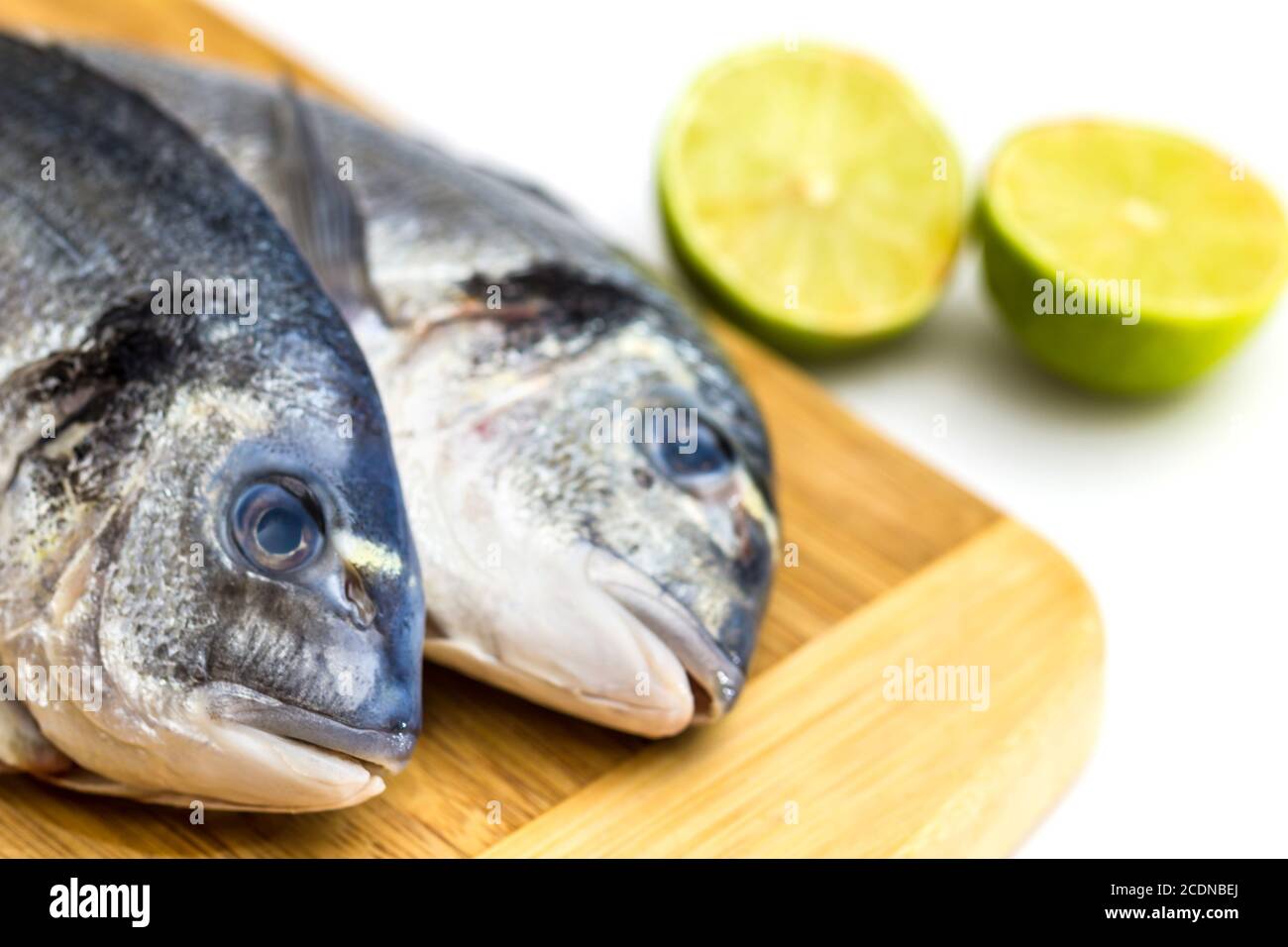 Bream fish with lime isolated on white background Stock Photo - Alamy