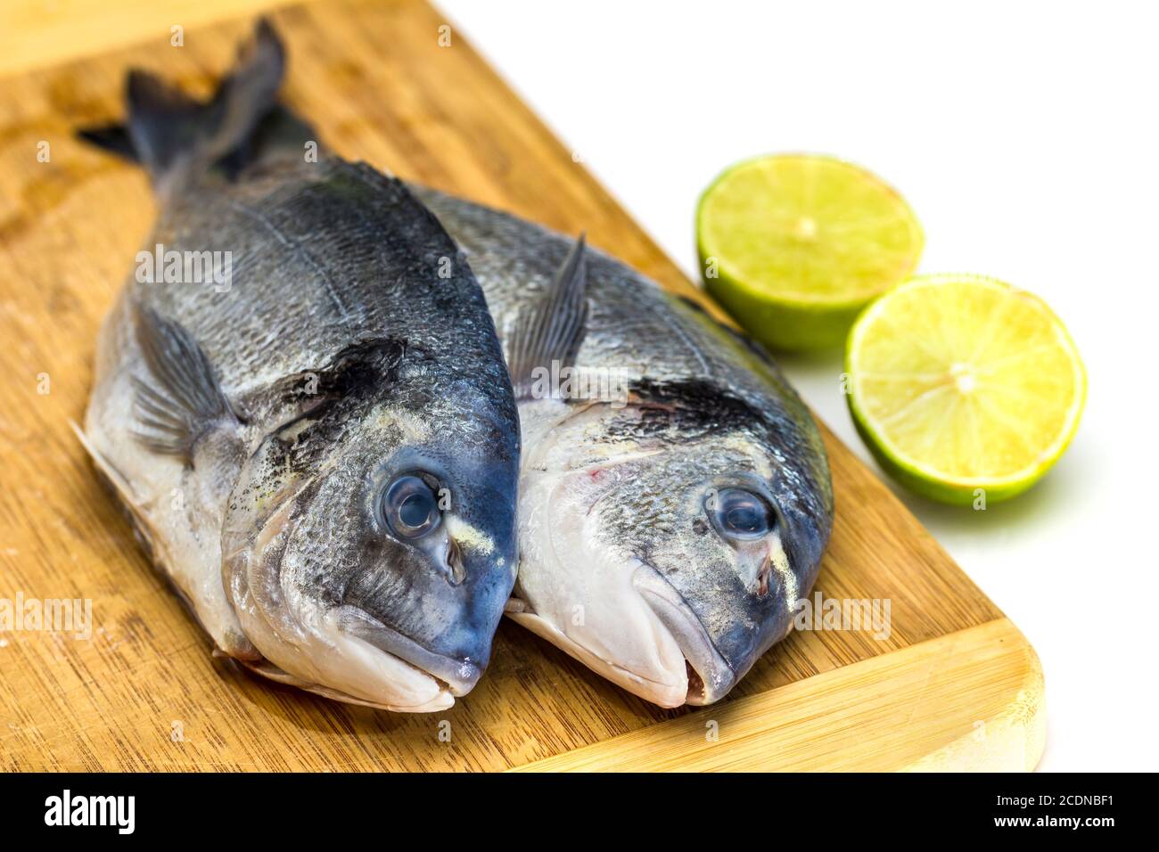 Bream fish with lime isolated on white background Stock Photo - Alamy