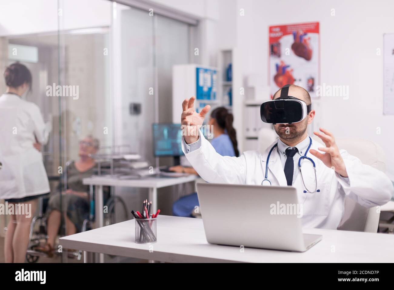 Doctor using futuristic augmented reality technology wearing headset in ...