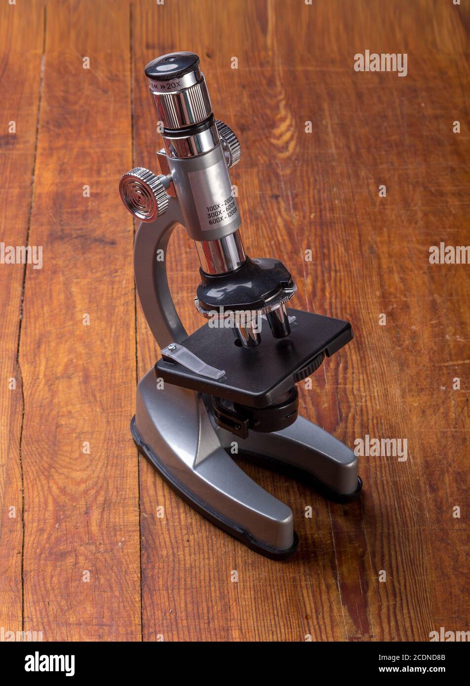 Microscope on table for vintage science background Stock Photo - Alamy