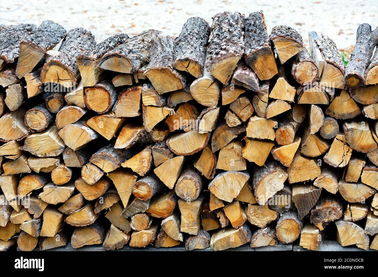 Coarsely chopped and neatly stacked oak wood texture prepared for the ...
